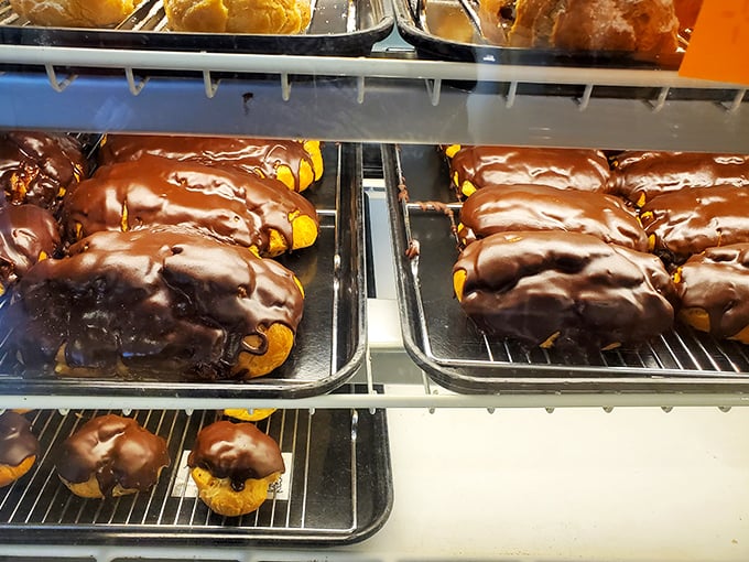 Chocolate-drenched eclairs lounging on trays like sunbathers at a pastry beach resort. Resistance is futile.