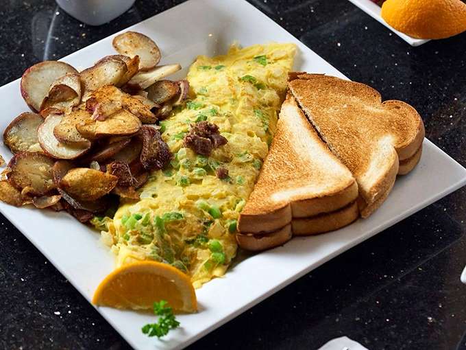 The holy trinity of breakfast: perfectly folded omelet, home fries with attitude, and toast standing by for yolk-soaking duty.
