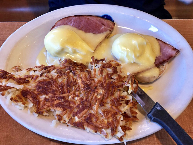Eggs Benedict with ham and crispy hash browns&mdash;the breakfast equivalent of a power suit. This plate means business, delicious business.