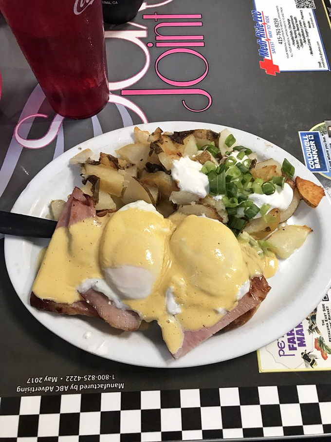 Eggs Benedict done right&mdash;perfectly poached eggs nestled on ham, draped in hollandaise, with home fries that didn't come from a freezer bag.