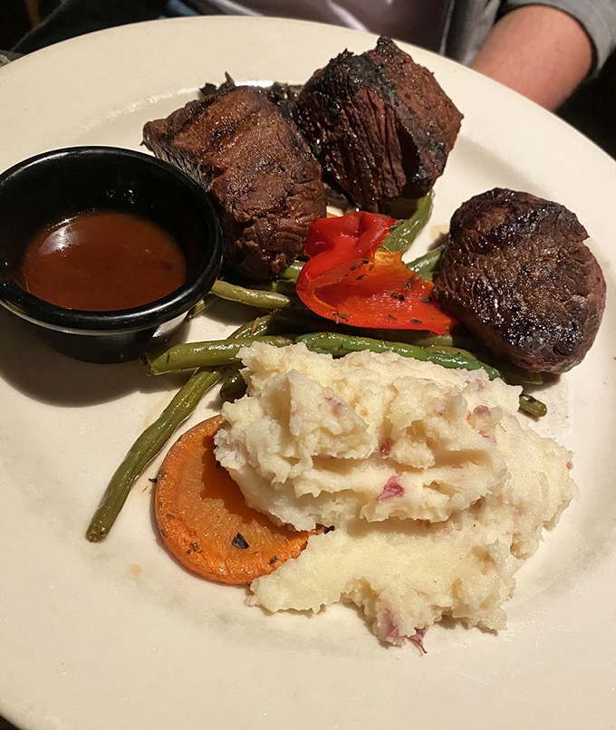 Elk medallions cooked to perfection&mdash;tender, flavorful, and arranged like meaty jewels. The mashed potatoes aren't just a side; they're a necessity.