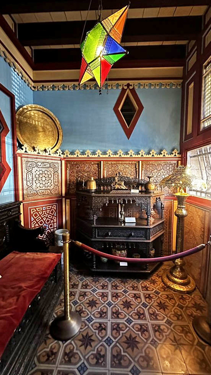 Colorful lanterns cast magical patterns across this room's blue walls and ornate furnishings&mdash;proof that maximalism worked beautifully long before it became an Instagram trend.