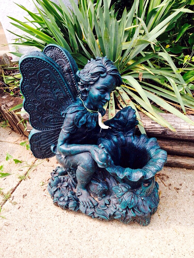 Garden statuary that adds whimsy to any outdoor space. This fairy figure proves that even concrete can look magical in the right hands. 