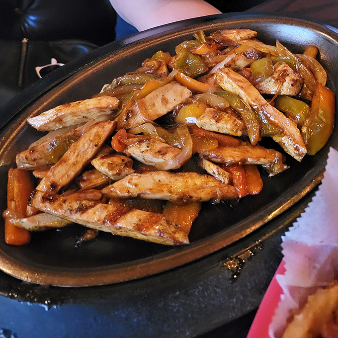 Sizzling fajitas that announce their arrival before you see them, with that perfect char that makes you wonder why you ever cook at home.