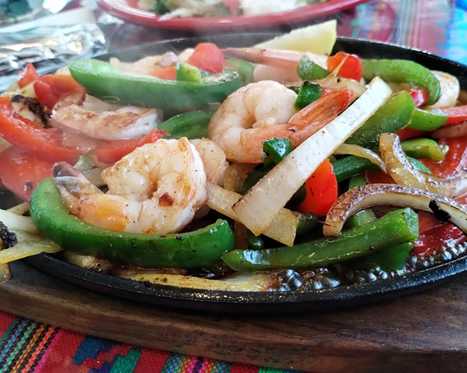 Sizzling fajitas that announce their arrival before you see them—like a delicious parade where vegetables and shrimp are the star performers.
