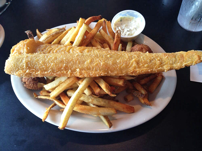 This fish fillet isn't just fried&mdash;it's been given a golden armor of crispy batter protecting the tender white fish within.