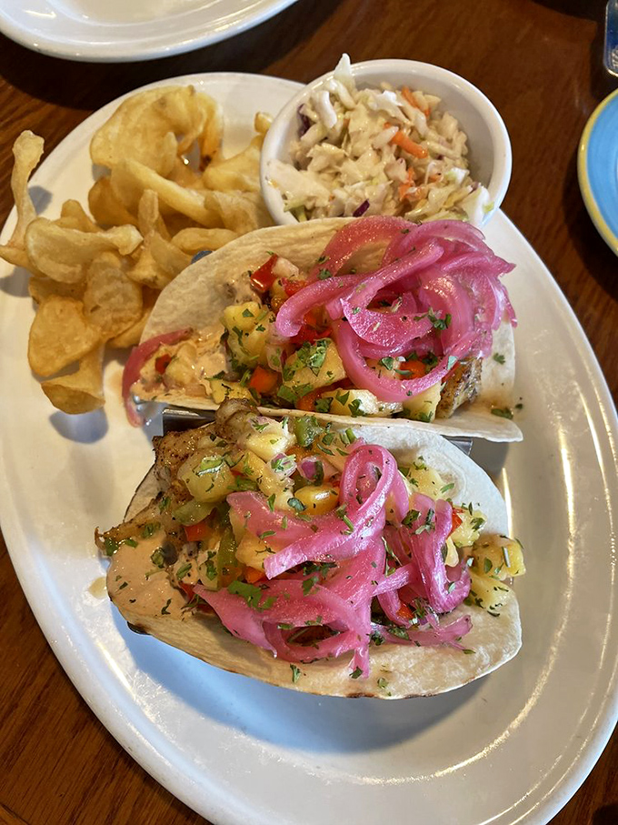 These fish tacos come with pickled onions so vibrant they could direct traffic. The perfect handheld vacation for your taste buds.
