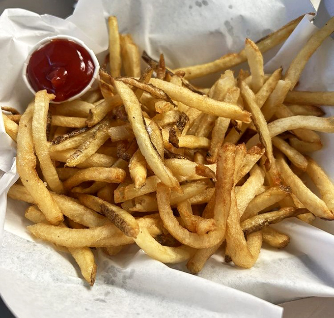 These hand-cut fries aren't just potato sticks; they're golden vehicles for ketchup delivery, crispy on the outside, fluffy within.