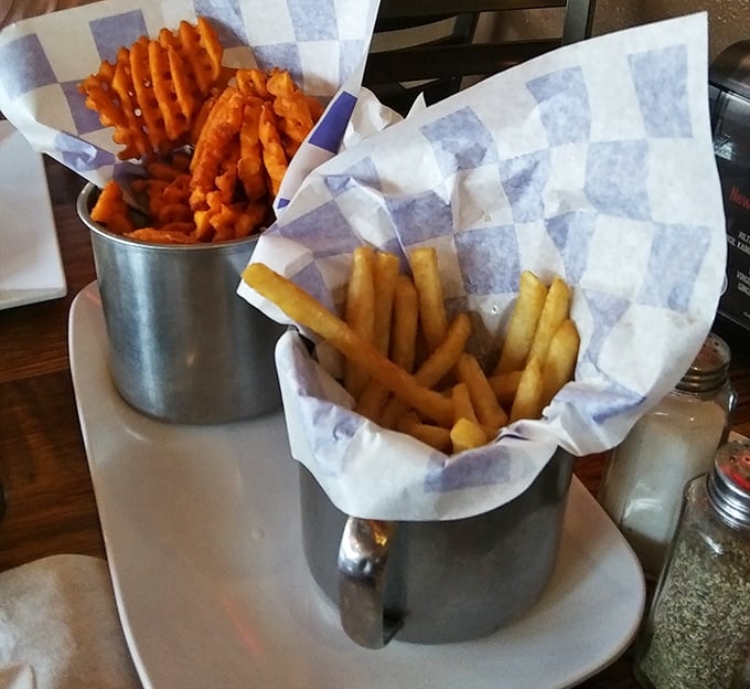 Regular and sweet potato fries served in metal cups&mdash;because sometimes the hardest choice in life is which potato to eat first.