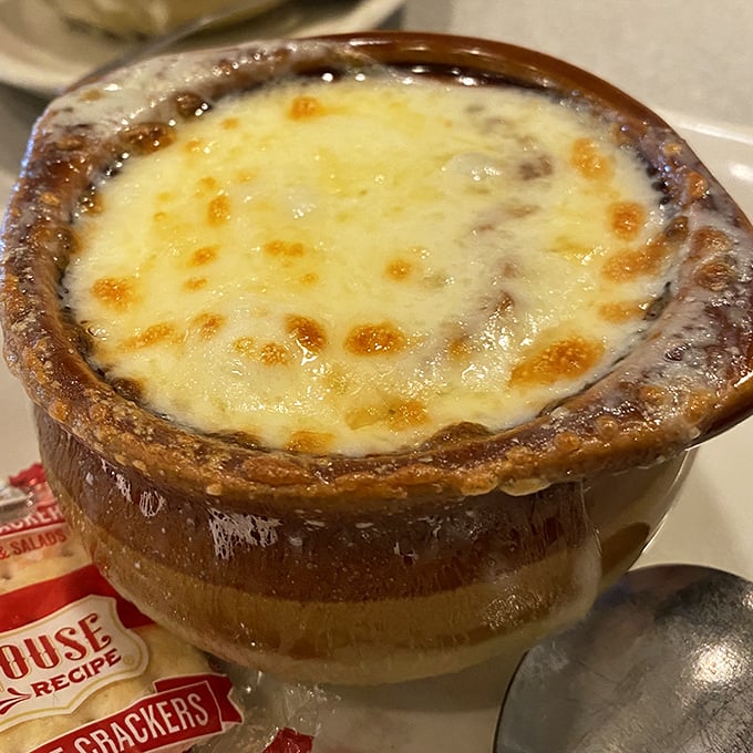 French onion soup that's wearing its cheese like a comfortable sweater. That broiled top is the crusty ceiling to a savory underground party.