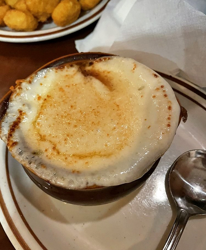 French onion soup bubbles with melted cheese perfection, warming souls one spoonful at a time.