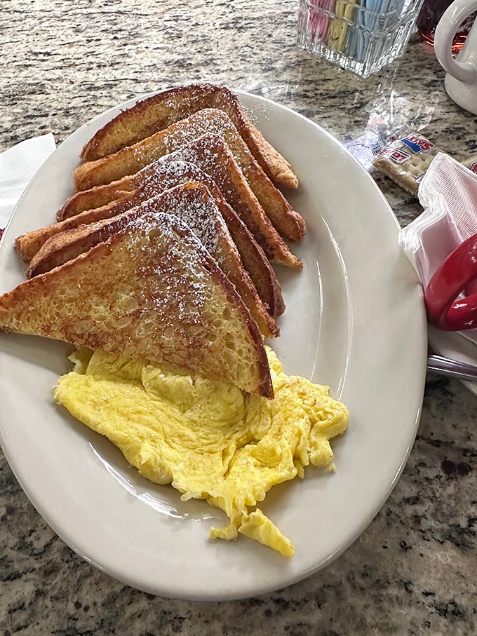 French toast so perfectly golden it belongs in Fort Knox, with scrambled eggs fluffier than the clouds in heaven's breakfast nook.