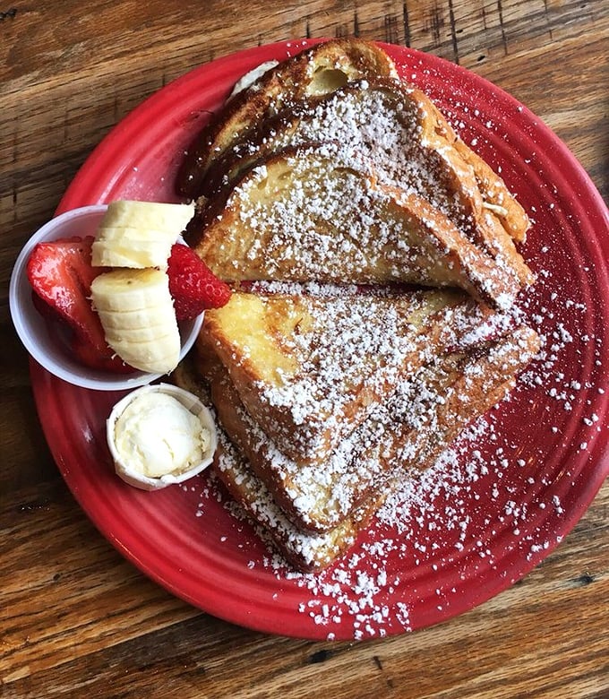 French toast that's dressed for success with powdered sugar snow and a fruit sidekick. Breakfast dessert? I'm not judging, I'm joining.
