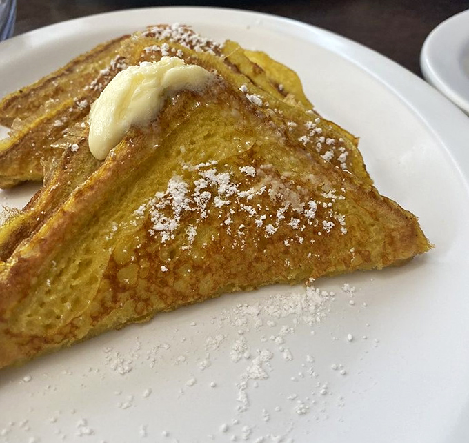 French toast that makes you question why anyone would eat regular toast. That dusting of powdered sugar? The culinary equivalent of freshly fallen snow.