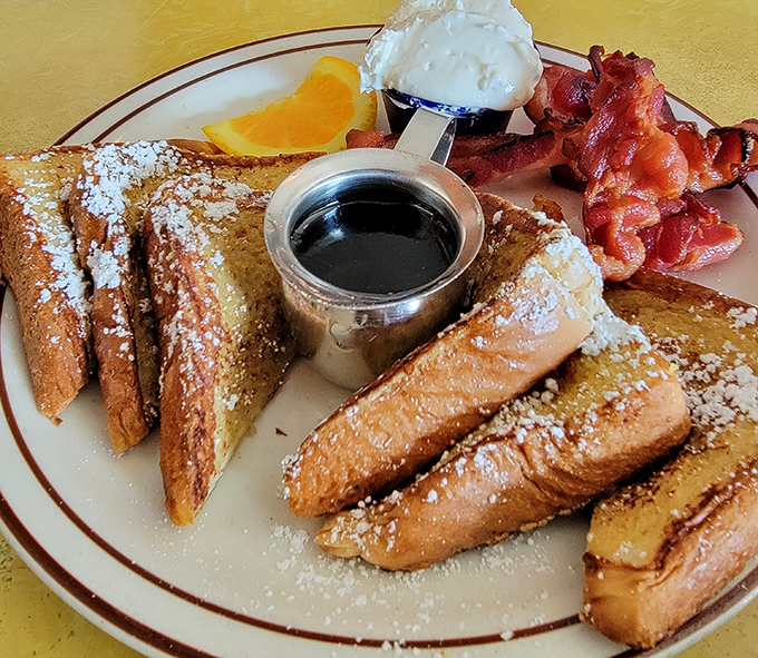 French toast that's dressed for success with powdered sugar, maple syrup, and bacon sidekicks that steal the spotlight.