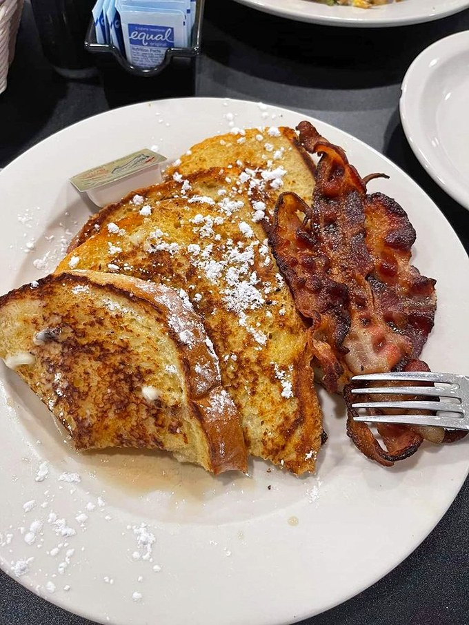 French toast dusted with powdered sugar and paired with bacon that's achieved that mythical balance between crispy and chewy&mdash;breakfast nirvana exists!