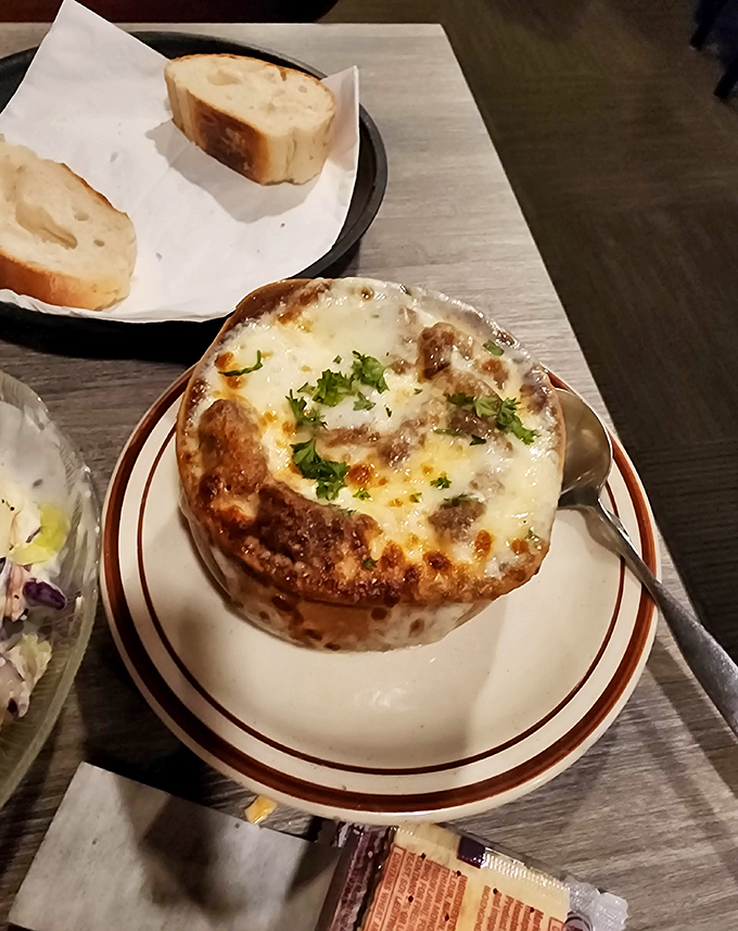 French onion soup so perfectly browned and bubbly, it's like a cheese volcano decided to erupt on your table.