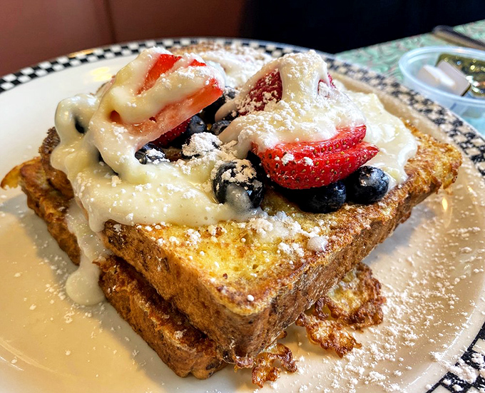 French toast that's having an identity crisis as a dessert&mdash;berries, cream, and powdered sugar creating breakfast's answer to heaven on a plate.