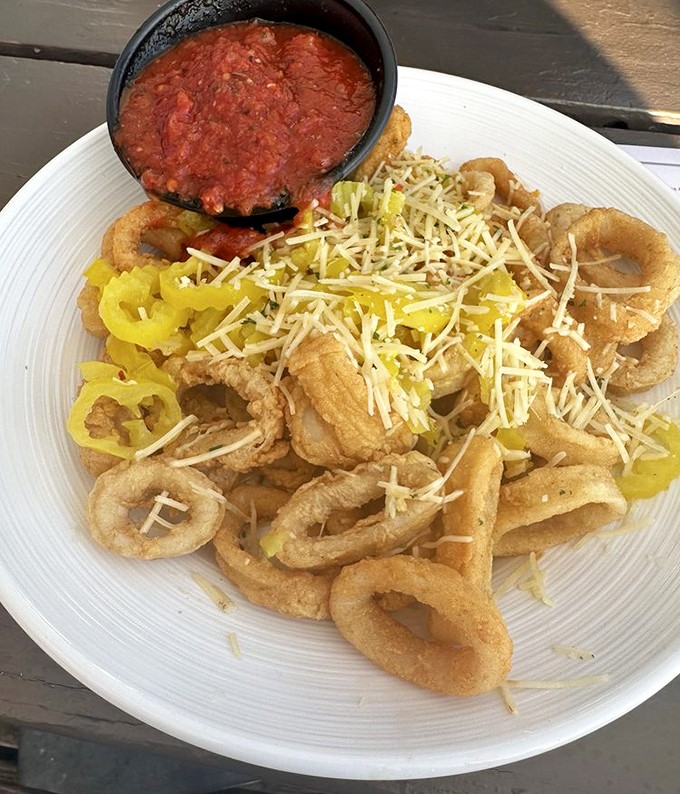 Crispy calamari rings showered with cheese and peppers – proof that sometimes the best things in life come in circular form.