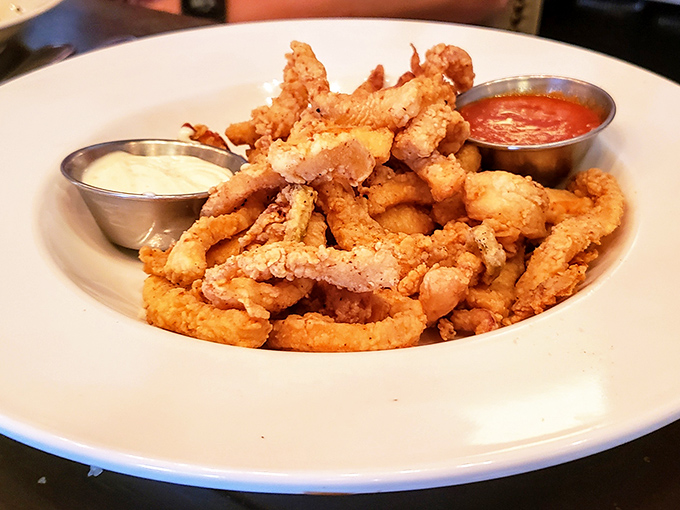 Crispy calamari that shatters with each bite, served with dipping sauces that make you forget you're eating something that once swam in the ocean.