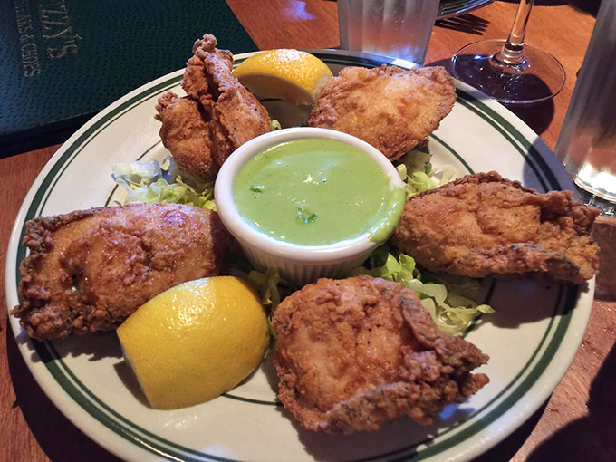 Golden fried oysters arrive like little treasure chests from the sea, each bite a briny burst of coastal heaven.