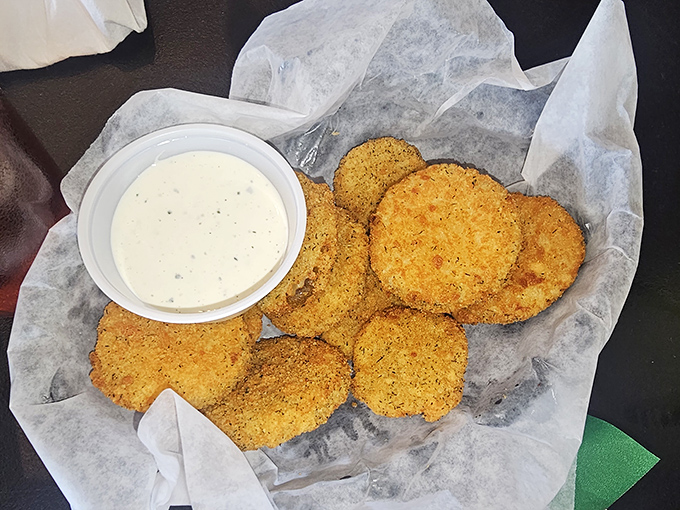 These aren't your average fried pickles – they're tangy discs of joy that somehow manage to stay crispy while delivering that perfect pickle punch.