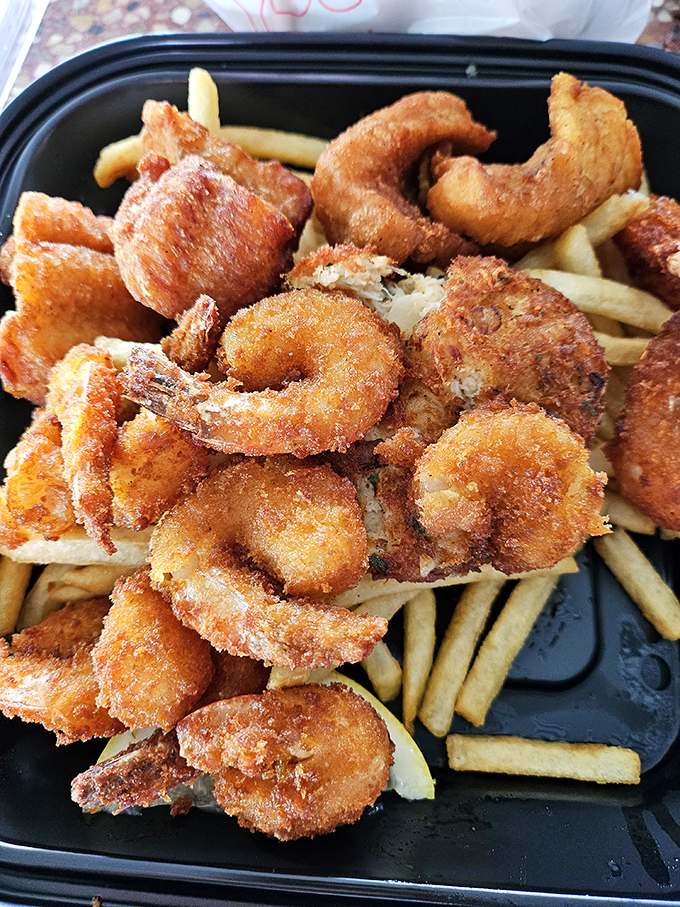 These golden-fried shrimp aren't just food; they're little crispy treasures nestled among French fries. Forget counting calories &ndash; start counting blessings.