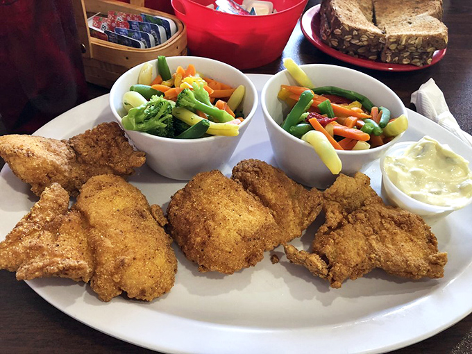Golden fried catfish paired with vegetables &ndash; proof that comfort food can play nice with nutrition.