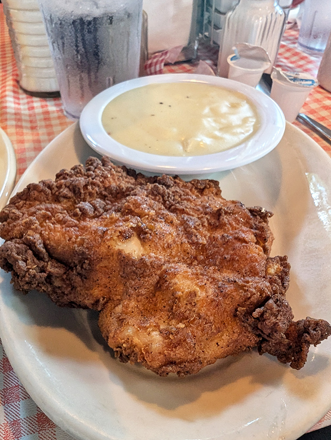 Fried chicken with a crust so perfect it deserves its own trophy, alongside gravy that's basically liquid comfort in a bowl.