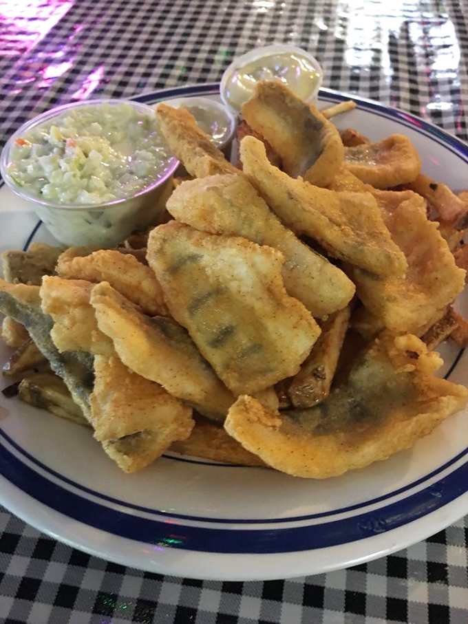 Perfectly breaded fish fillets that shatter with each bite, served alongside creamy coleslaw &ndash; proof that simple food done right is worth celebrating.
