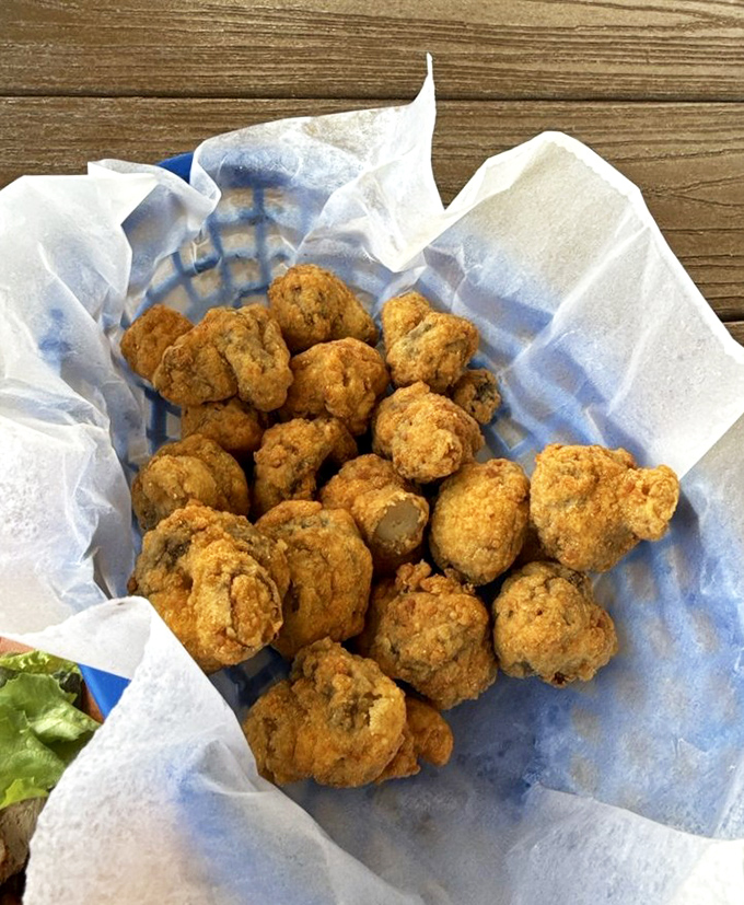 Fried mushrooms that look like they've been dipped in sunshine – crispy little flavor bombs waiting to be dunked in that creamy sauce.