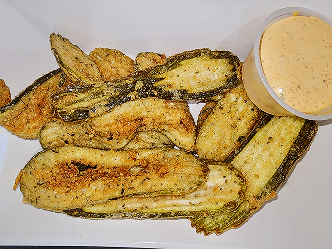 Fried pickles that crunch louder than your dad walking on hardwood floors at 2 AM. The dipping sauce is just the encore.