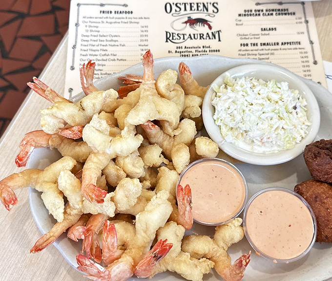 The famous St. Augustine fried shrimp arrive like pale golden treasures, lightly breaded to let the sweet shellfish shine. The coleslaw provides the perfect cool contrast.