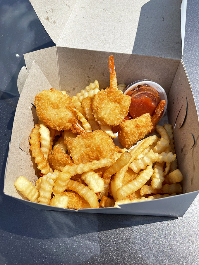 Plump shrimp nestled among golden fries deliver oceanic bliss in this perfectly portable cardboard treasure chest.