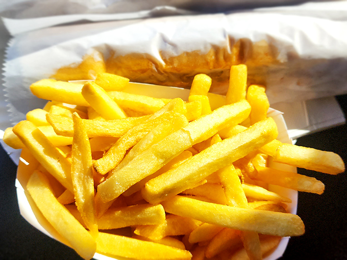 French fries so golden they could fund your retirement. Crisp, hot, and salty &ndash; the holy trinity of potato perfection.