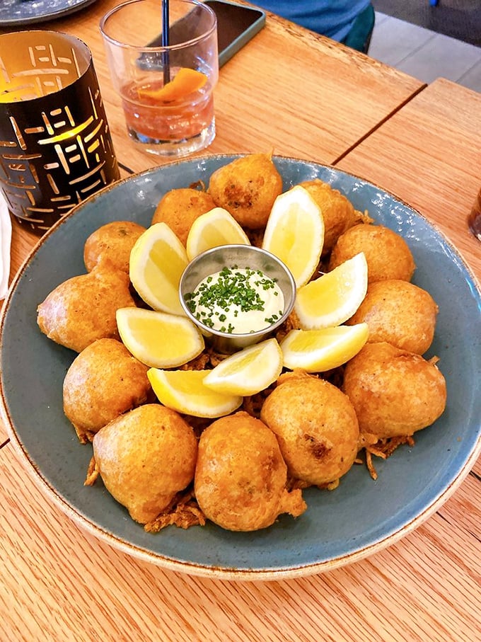 Golden-fried perfection arranged like a sunburst. These fritters with lemon wedges and dipping sauce are what your childhood self always hoped adulthood would taste like.