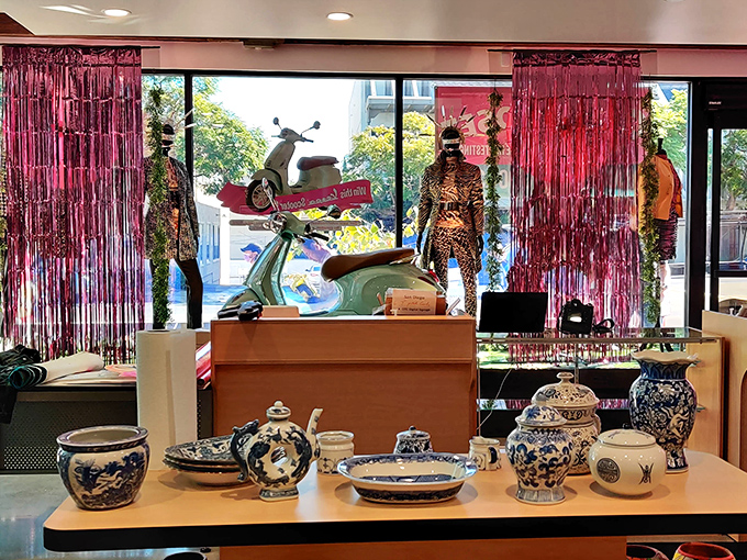 Window shopping reaches new heights with this artful display featuring vintage ceramics and a mint-condition Vespa that screams "La Dolce Vita!"