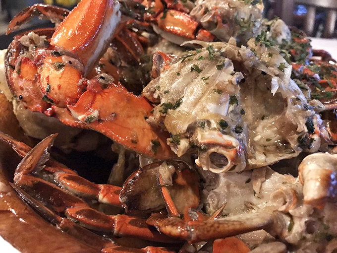 The legendary garlic crabs—butter-soaked, herb-flecked, and messy enough to require both a bib and possibly a post-meal shower. Worth every napkin.
