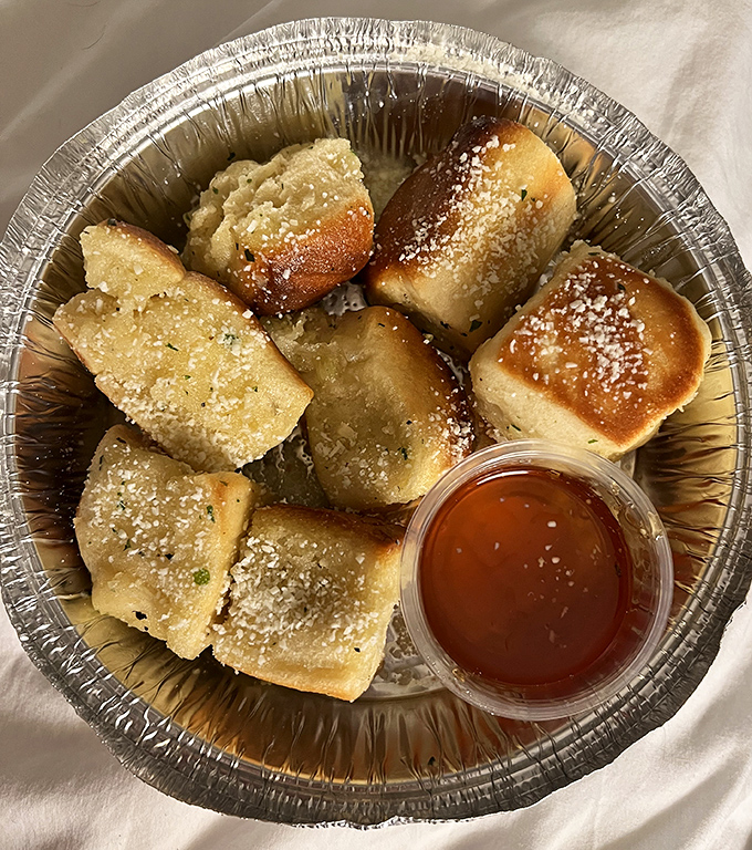 Garlic Pillows dusted with parmesan and served with honey&mdash;carbs that deserve their own category in the food pyramid.
