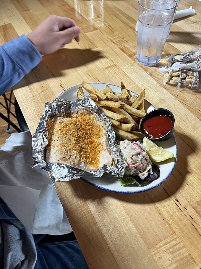 The garlic whitefish arrives wrapped in foil like a present, revealing tender fish bathed in butter and seasonings that would make Neptune himself request seconds.