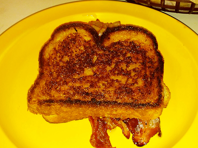 Grilled cheese perfection that would make your grandmother nod in approval, with bacon playing a supporting role worthy of an Oscar.
