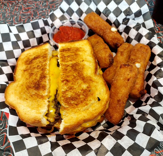 The perfect grilled cheese doesn't exi&mdash; Wait, it does! Golden-brown exterior, melty interior, with mozzarella sticks standing guard alongside.