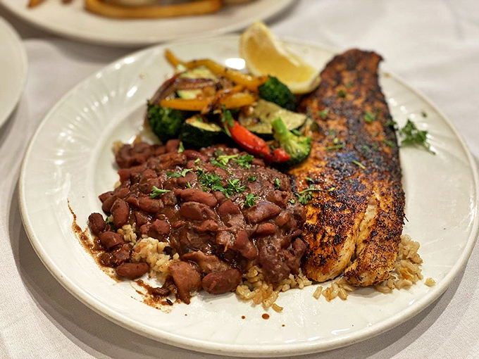 Grilled cobia with red beans and rice – a plate that captures Florida's culinary soul. The perfect marriage of spice, smoke, and the ocean's bounty.
