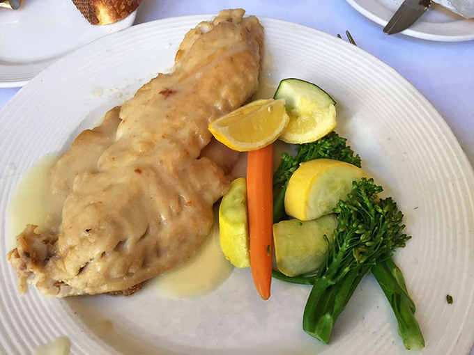 The Petrale sole arrives bathed in a delicate sauce that whispers rather than shouts, allowing the fresh fish to be the star of this culinary show.