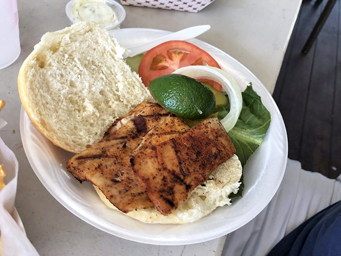 The grouper sandwich: proof that sometimes the best things in life are simply a perfect piece of fish, lightly seasoned, between two pieces of bread.