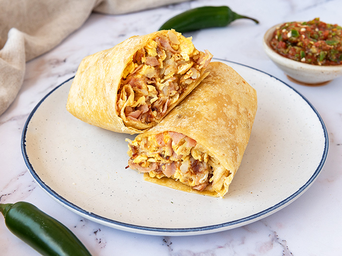 The ham breakfast burrito&mdash;where morning protein meets pillowy eggs in a tortilla embrace. Like a warm hug from a friend who really gets you. 