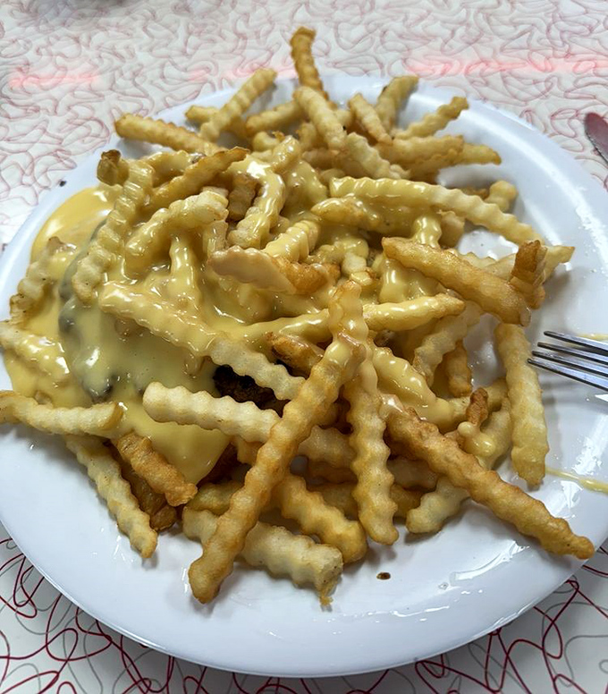 Crinkle-cut fries swimming in cheese sauce – the Horseshoe's foundation that proves sometimes architectural genius comes from the simplest of ingredients stacked just right.