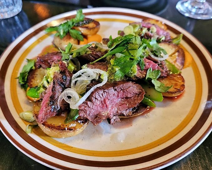 Hanger steak cooked with the respect it deserves&mdash;medium-rare perfection resting on grilled potatoes. Those fresh herbs aren't just pretty, they're necessary.