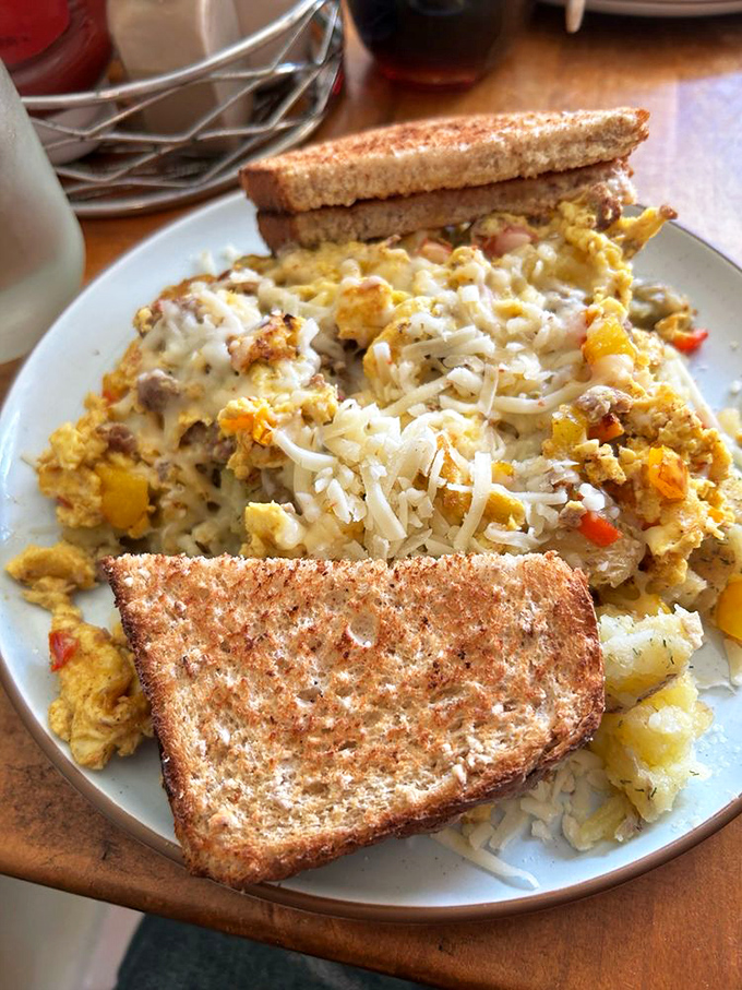 A breakfast symphony in three movements: perfectly scrambled eggs, crispy toast, and home fries that could make a potato farmer weep with pride.