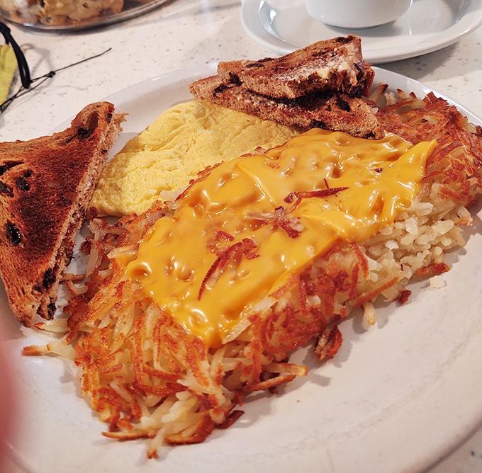 Hashbrowns wearing a melted cheese tuxedo &ndash; the kind of breakfast sidekick that deserves its own fan club and commemorative t-shirt.